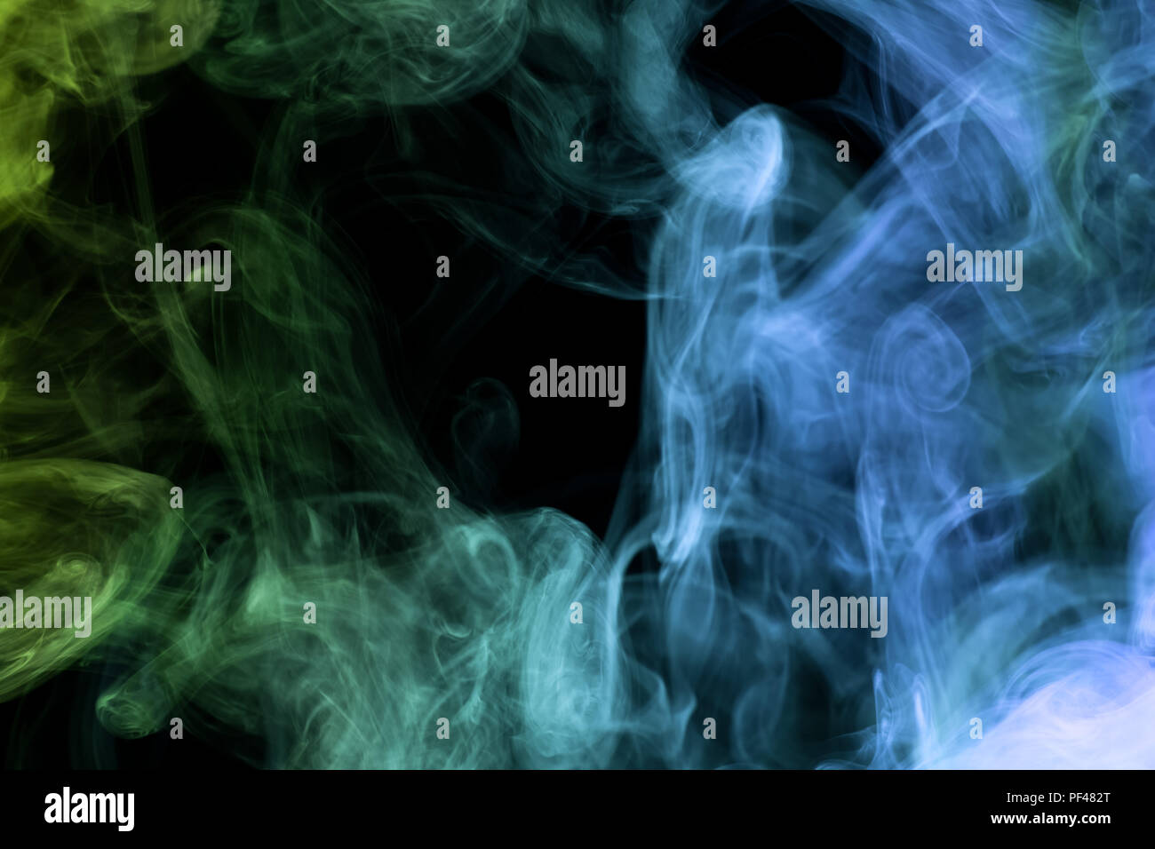 Thick blue and green smoke on a black isolated background. Background ...