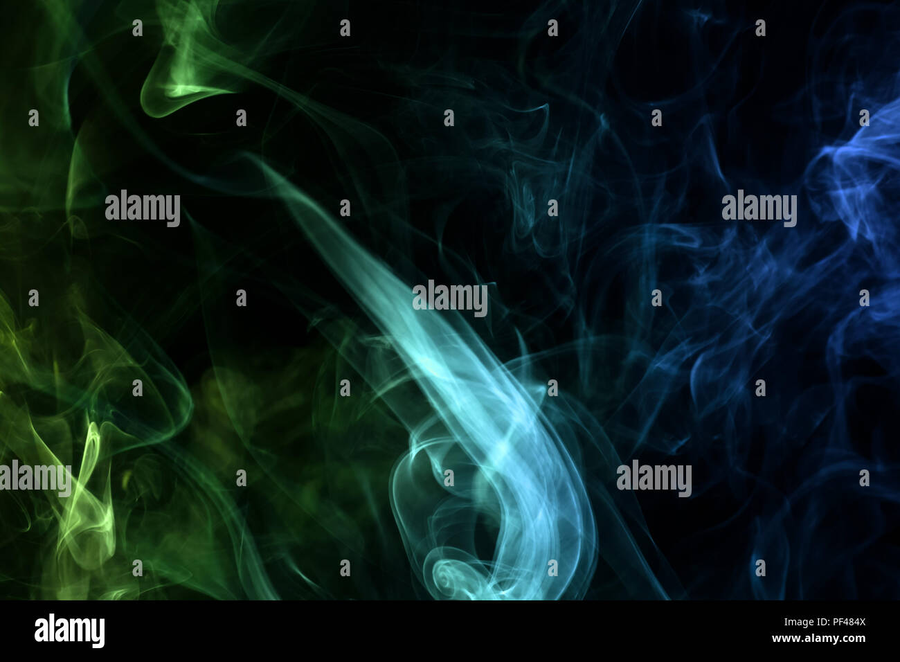 Cloud of green and blue smoke on a black isolated background ...
