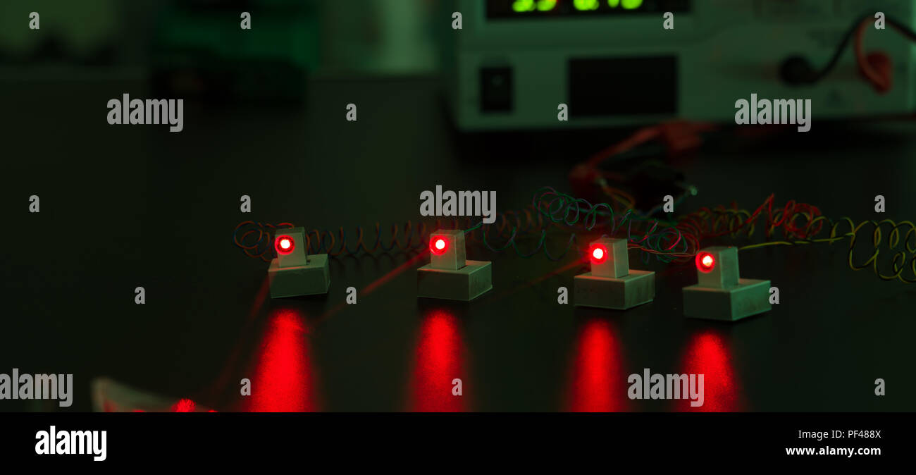 Experiment in the laboratory of Photonics with red lasers Stock Photo ...