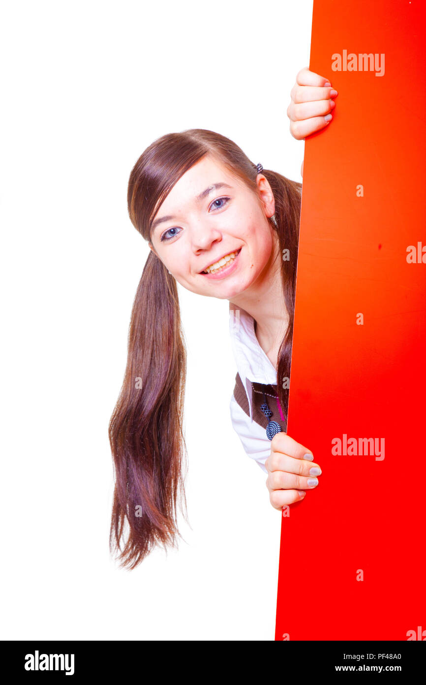 Teenage woman / girl hiding behind a board Stock Photo - Alamy