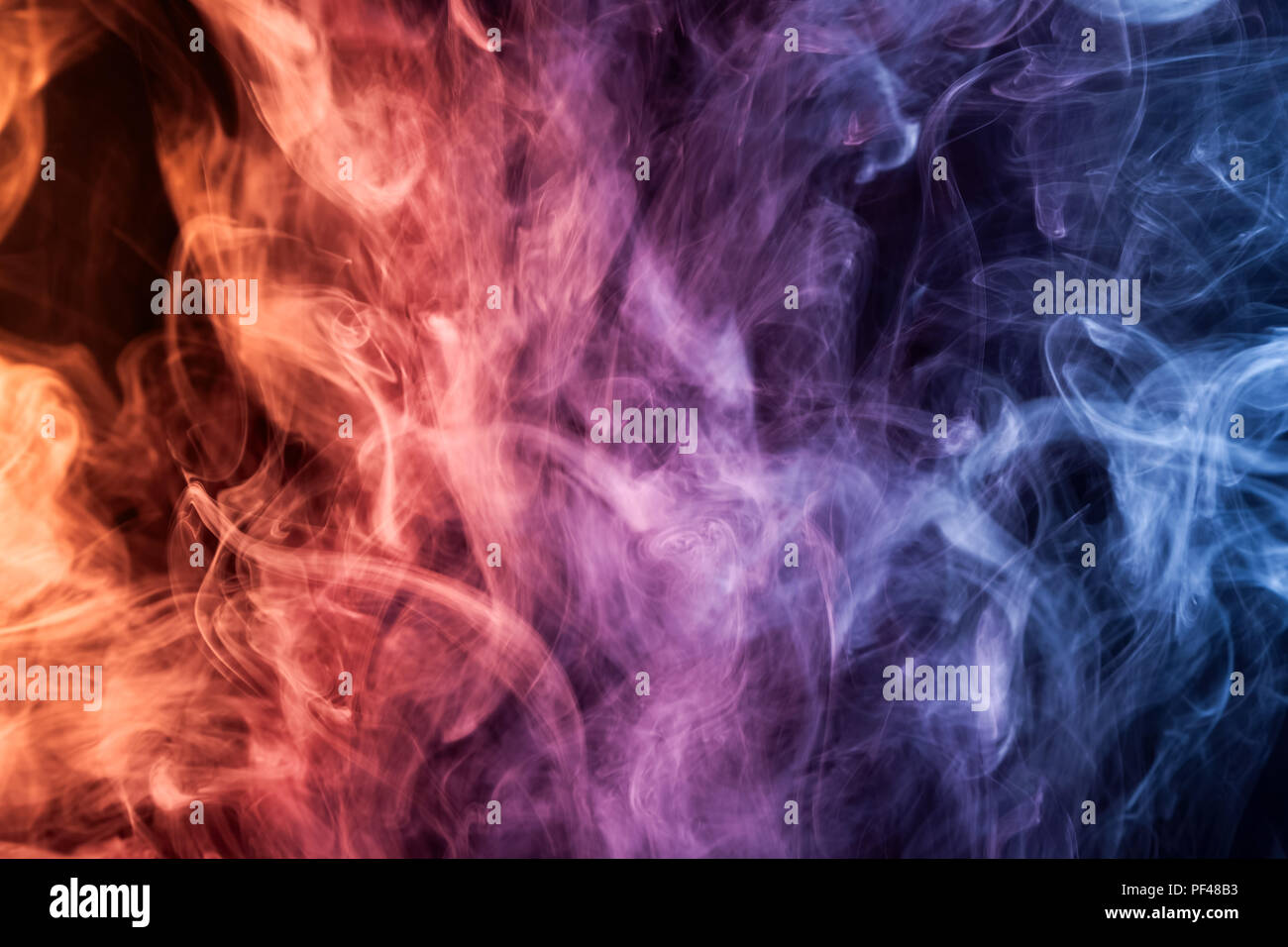 Red, blue and purple smoke on black background Stock Photo - Alamy