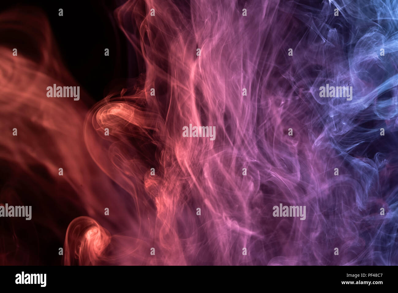 Red, blue and purple smoke on black background Stock Photo - Alamy