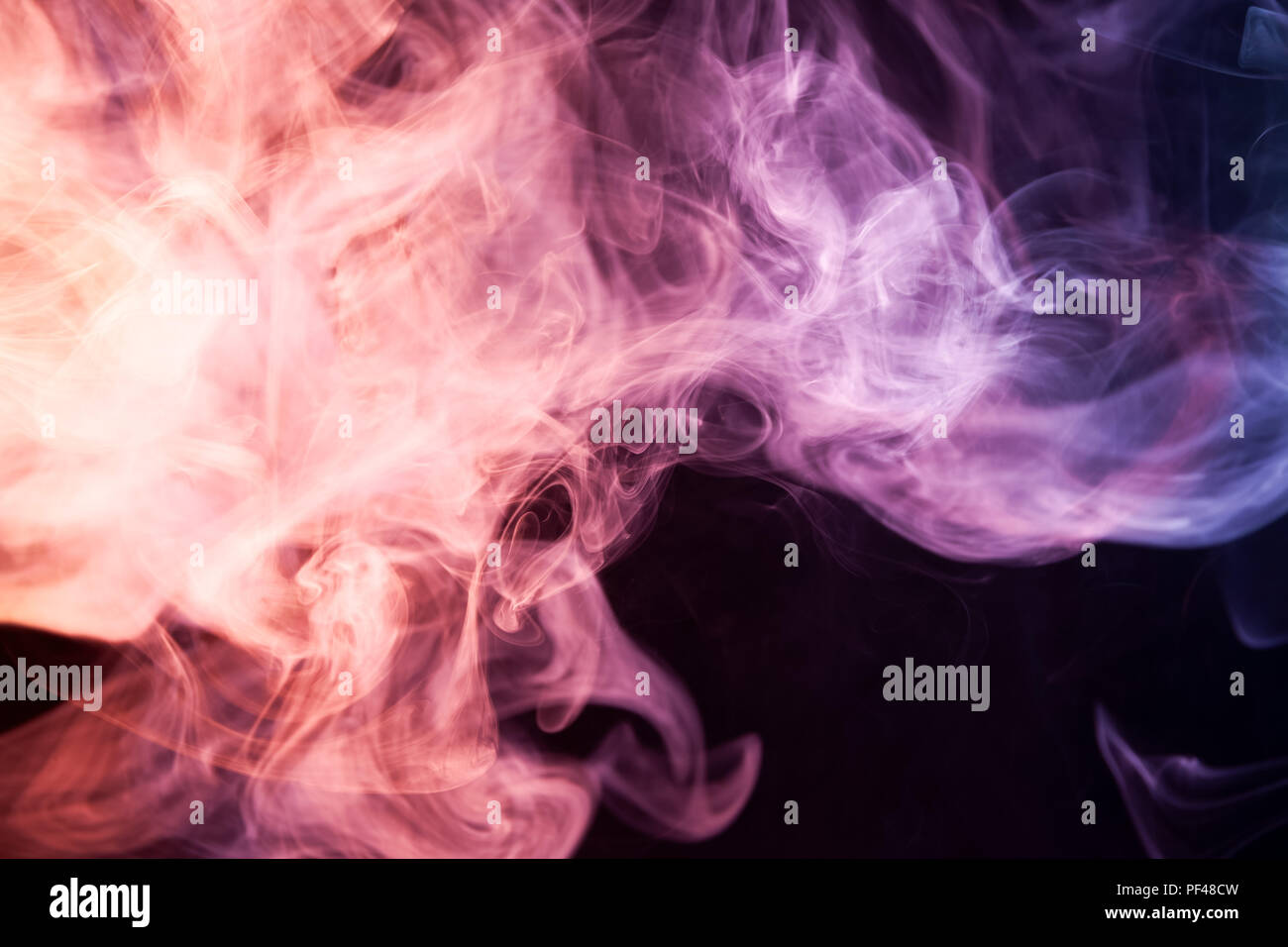 Red, pink and purple cloud of smoke of black isolated background ...