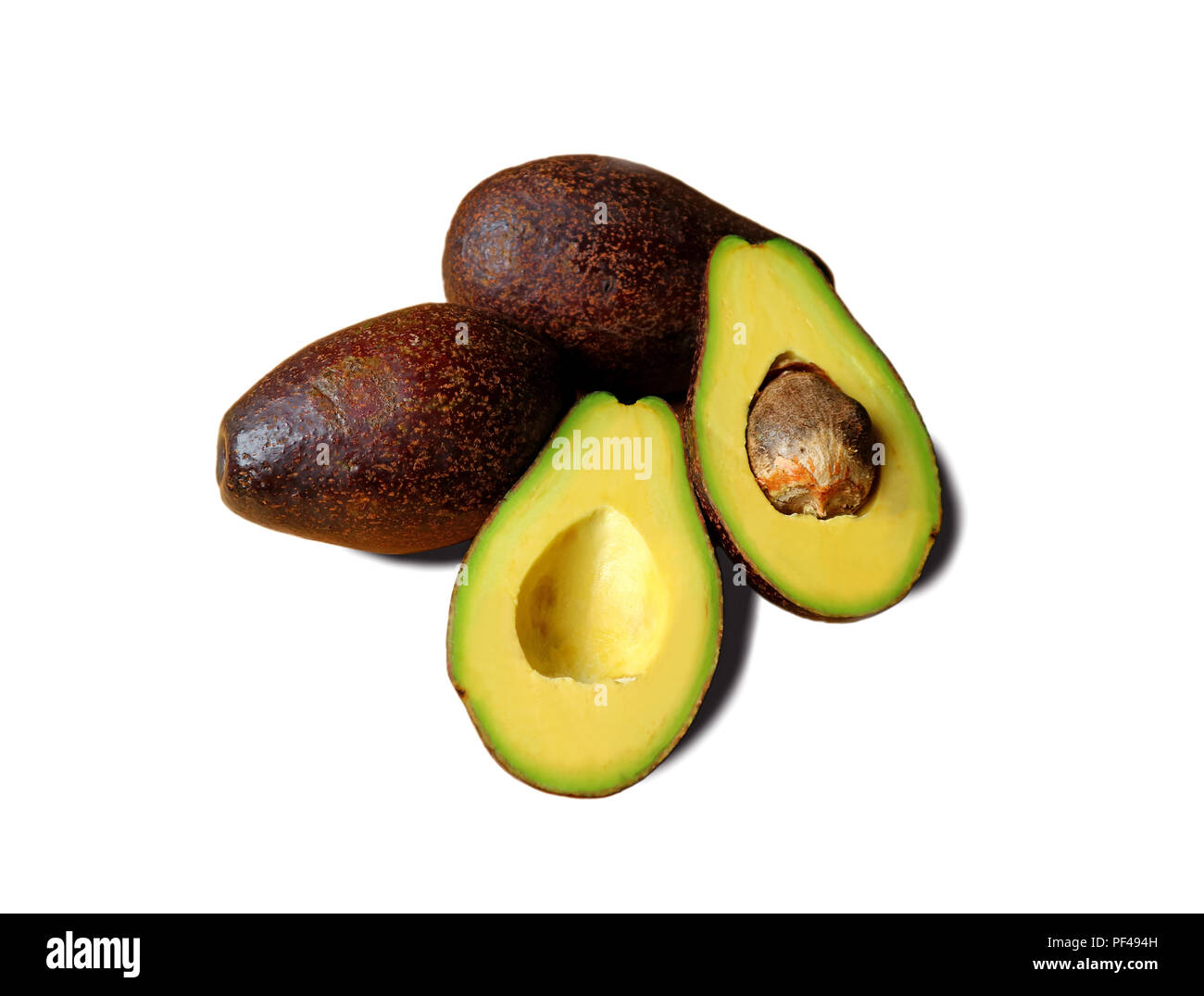 Ripe Avocados whole fruits and cut in half isolated on white background ...