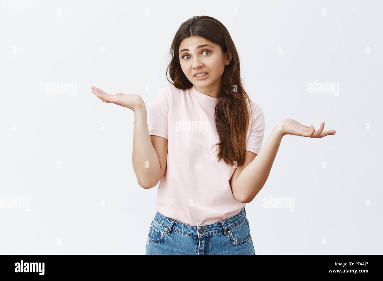 Indoor shot of confused and unsure attractive european female brunette ...