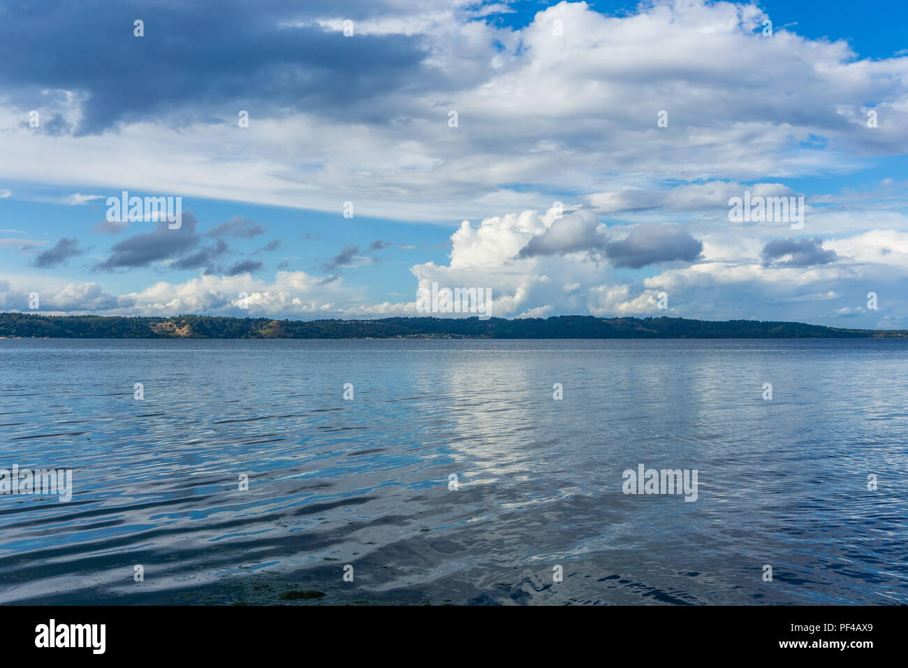 Billowing clouds hover over Maury Island in Washington State Stock ...
