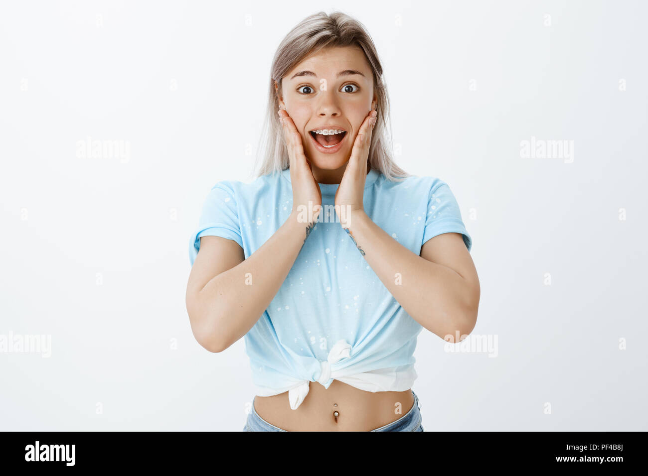 Portrait of shocked attractive woman trembling from surprise and ...