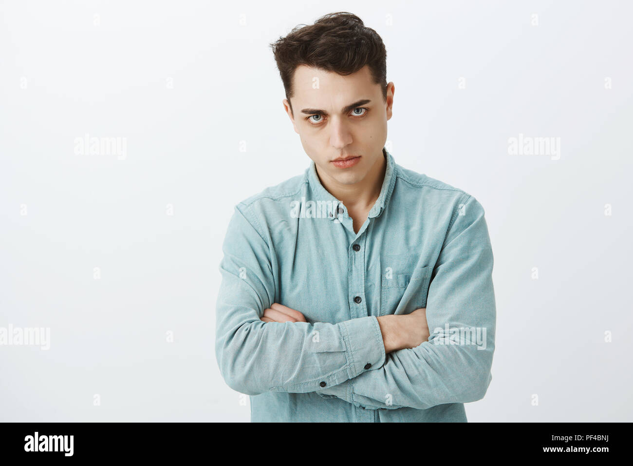 Portrait of offended pissed off european man in shirt, holding hands ...