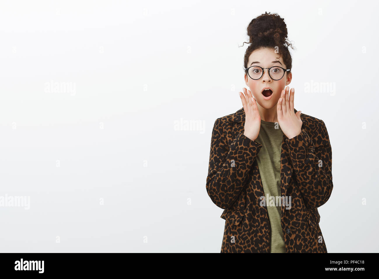 Portrait of shocked surprised girlfriend in leopard coat and black ...