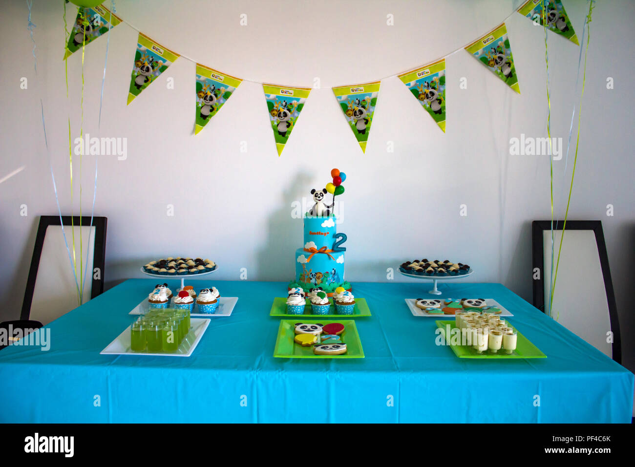 Birthday table with cake and desserts Stock Photo - Alamy