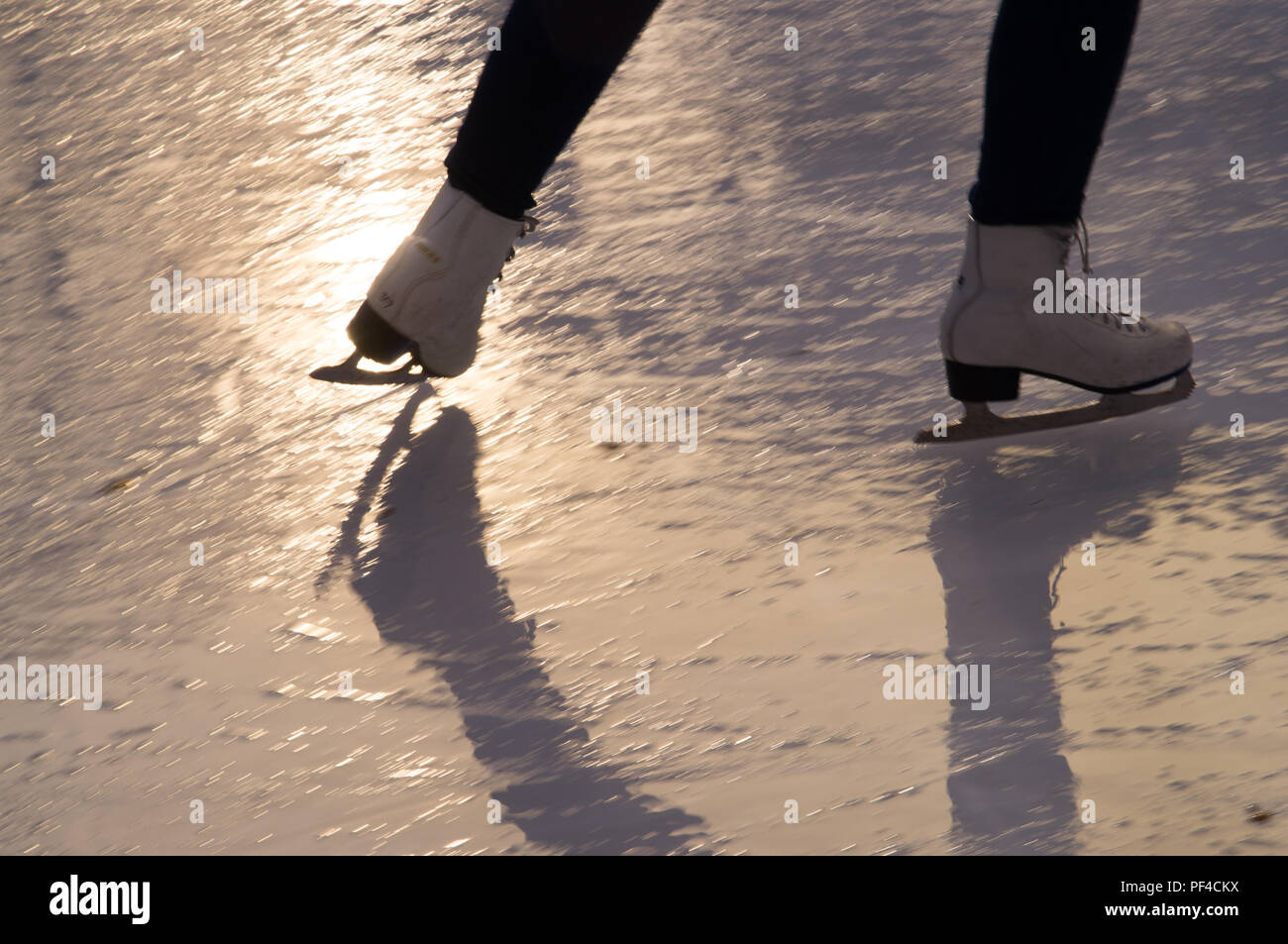 Ice skating on melting ice during sunset Stock Photo - Alamy