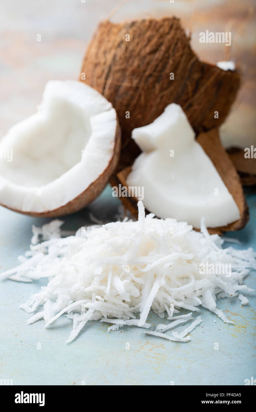 Fresh coconut flakes on a blue background Stock Photo - Alamy