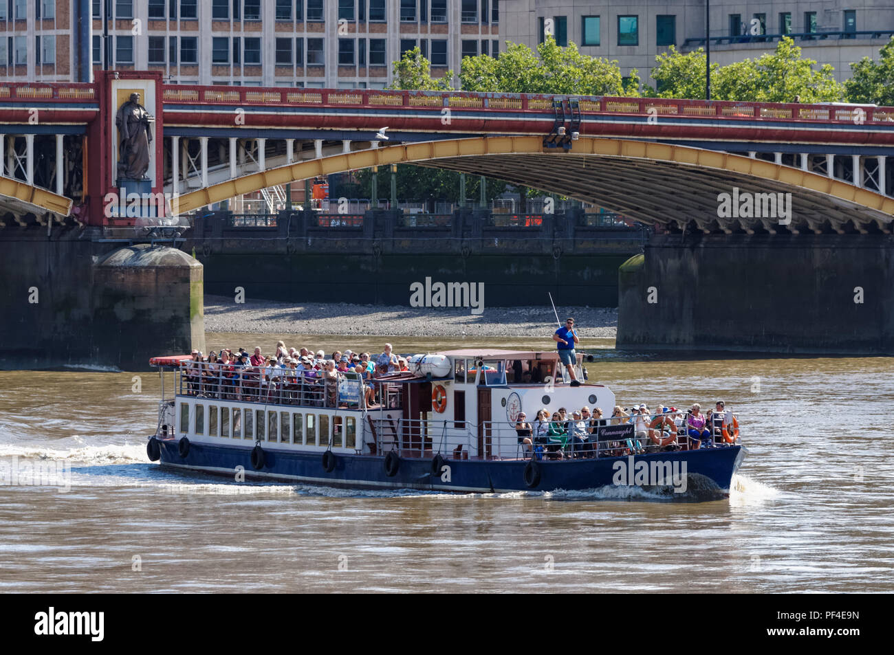 Cruise boat passing under the Vauxhall Bridge on the River Thames in ...