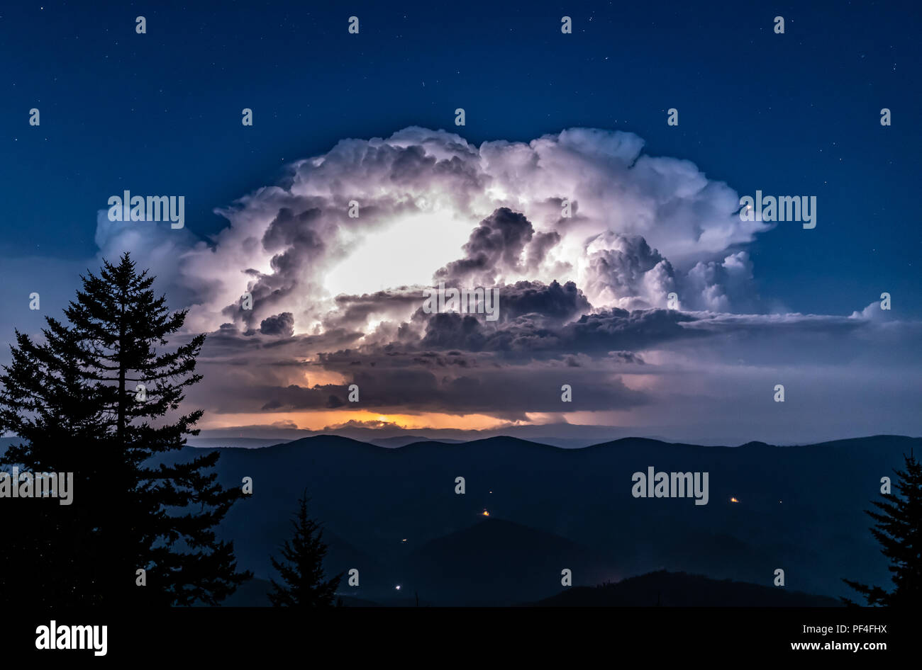 A huge thunderstorm with active lightning lighting up the clouds is ...