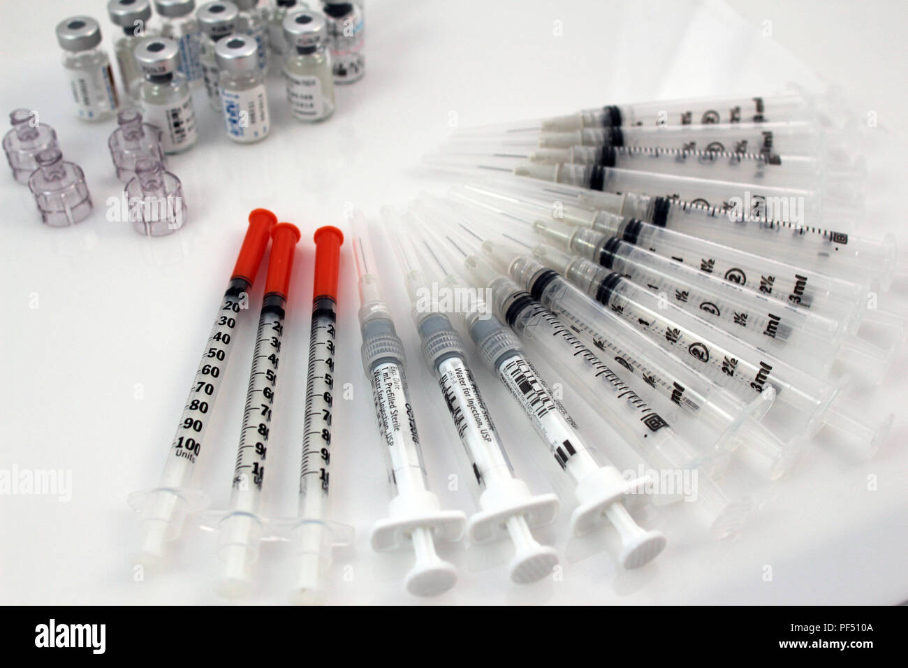 Syringes and medical vials for IVF treatment on a white background ...