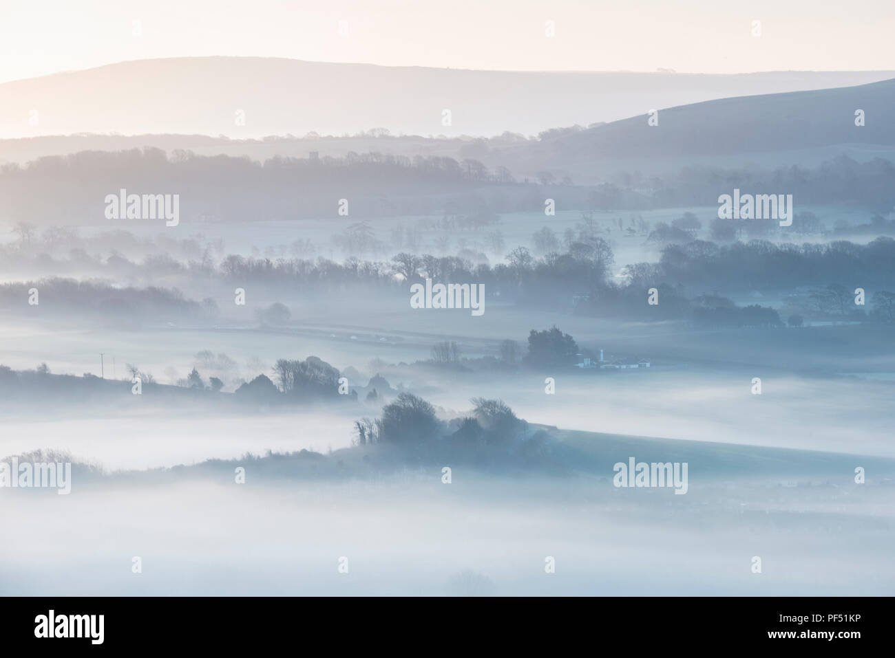 Beautiful foggy English countryside landscape at sunrise in Winter with ...