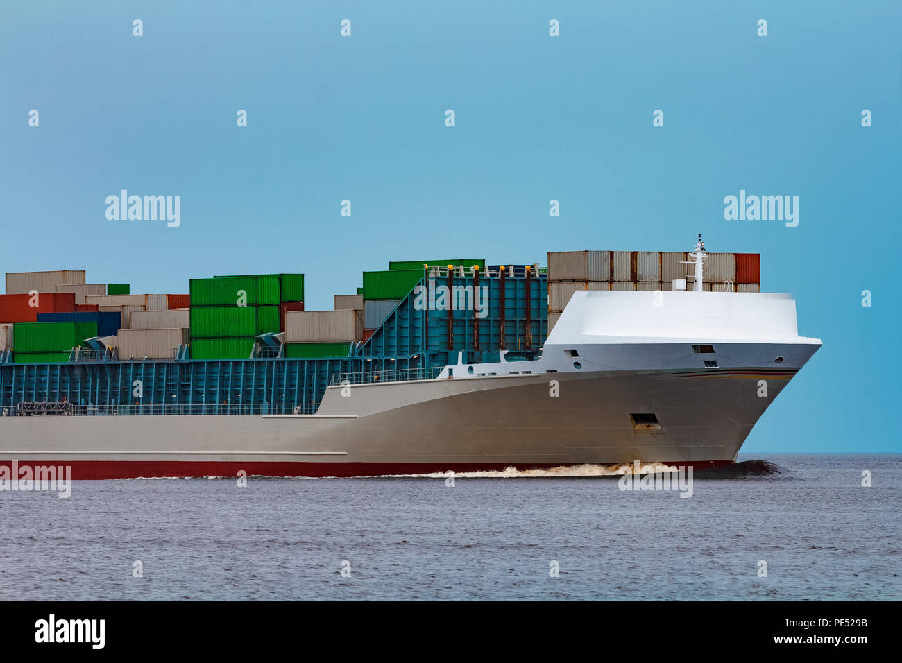 Grey container ship. Logistics and production import Stock Photo - Alamy