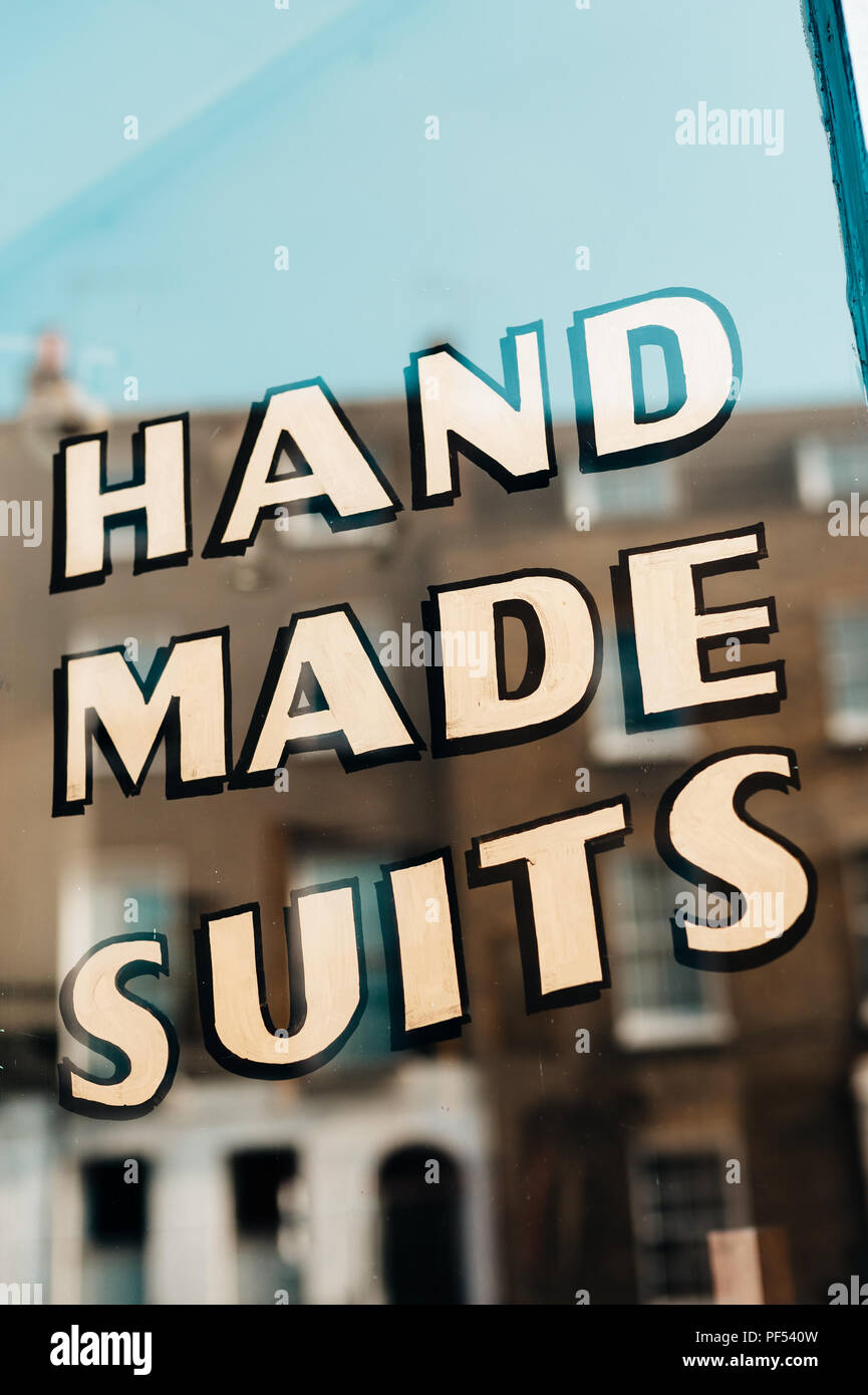 "Hand made suits" hand-painted sign Stock Photo - Alamy