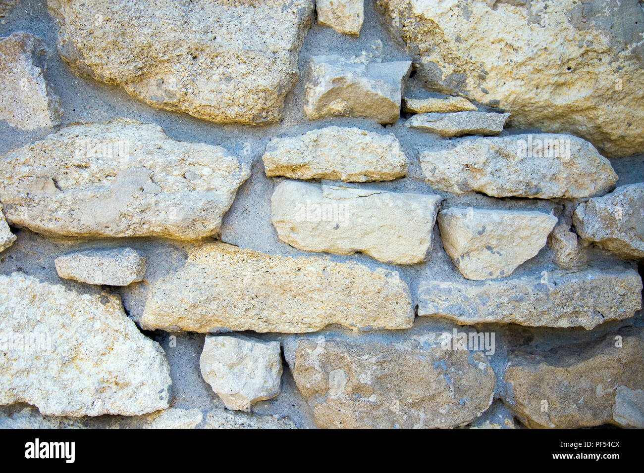 Fragment of a wall from a chipped stone. Stone texture. Stone tile ...