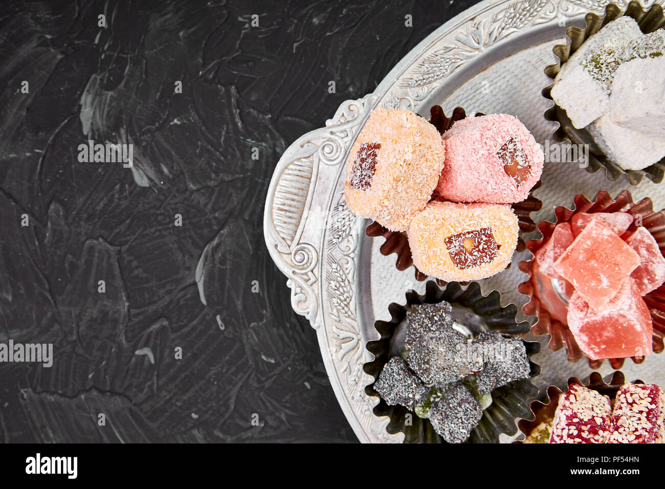 Set of various Turkish delight in traditional silver bowl on metal tray ...