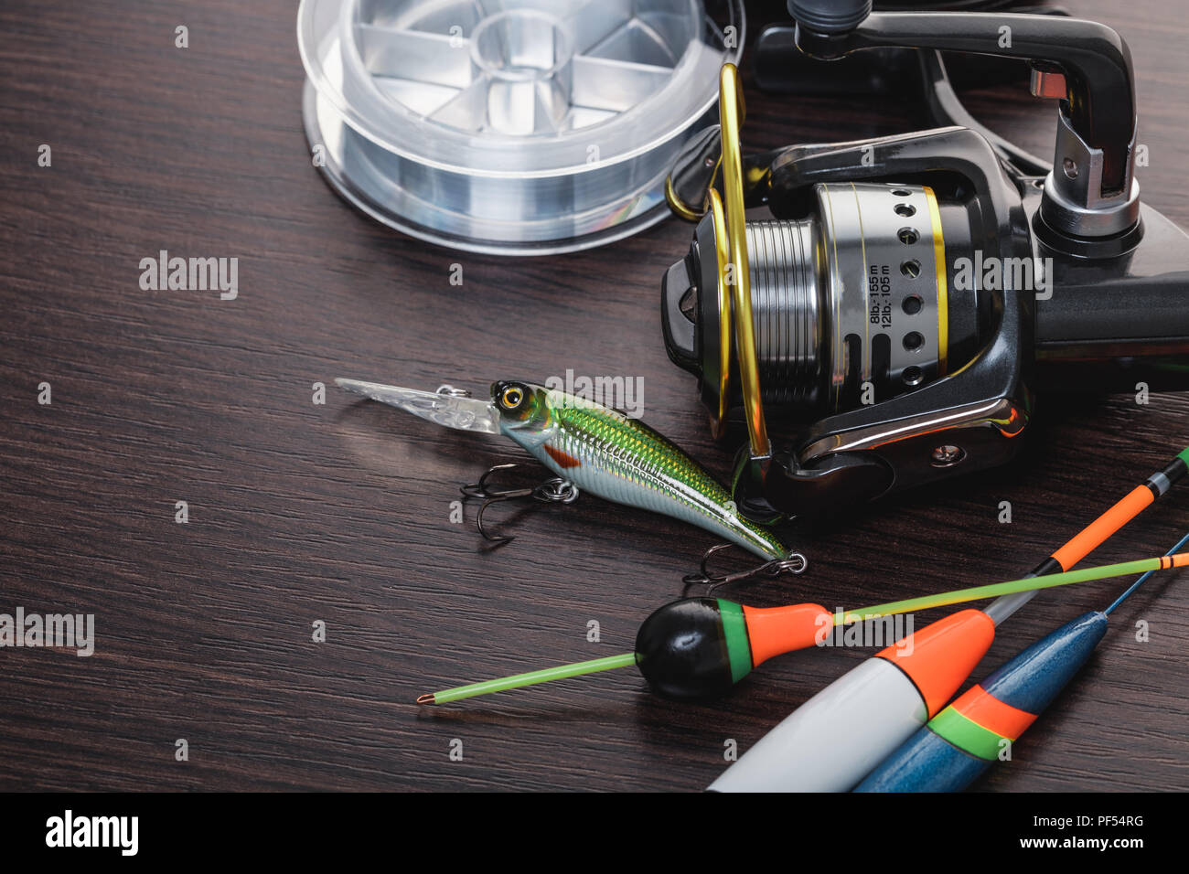 Coil and floats for a fishing rod on a wooden background Stock Photo ...