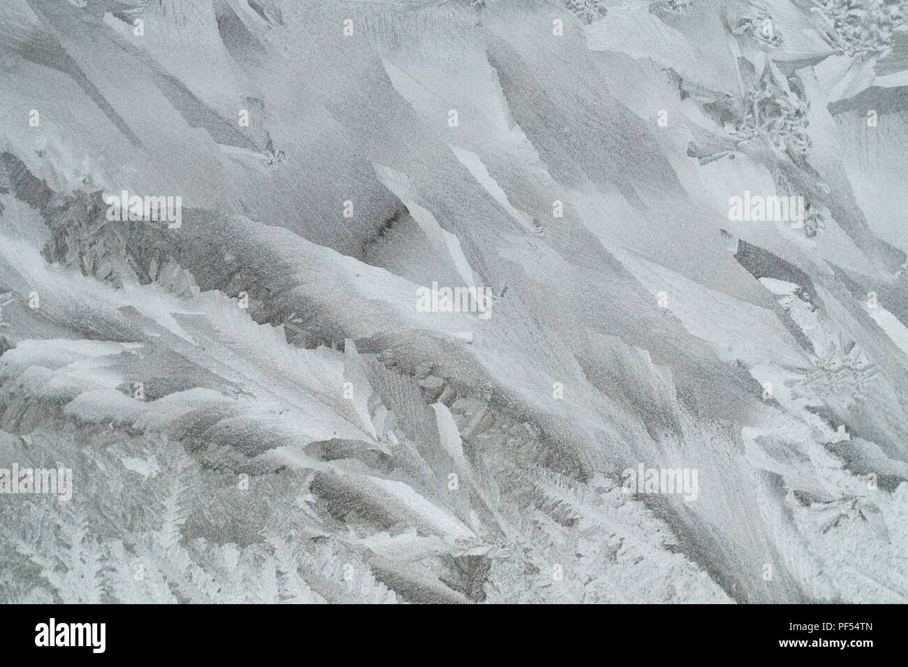 Frozen ice patterns on glass Stock Photo - Alamy