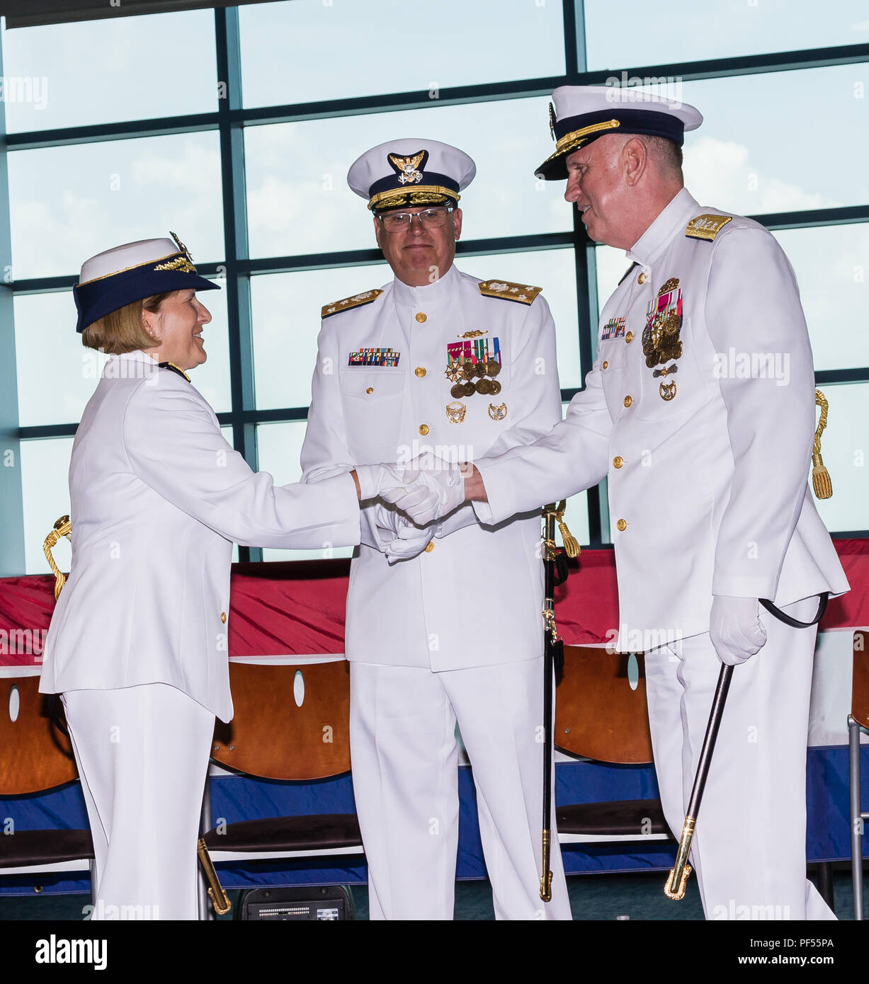 Coast Guard Rear Adm. Meredith Austin shakes hands with Rear Adm. Keith ...
