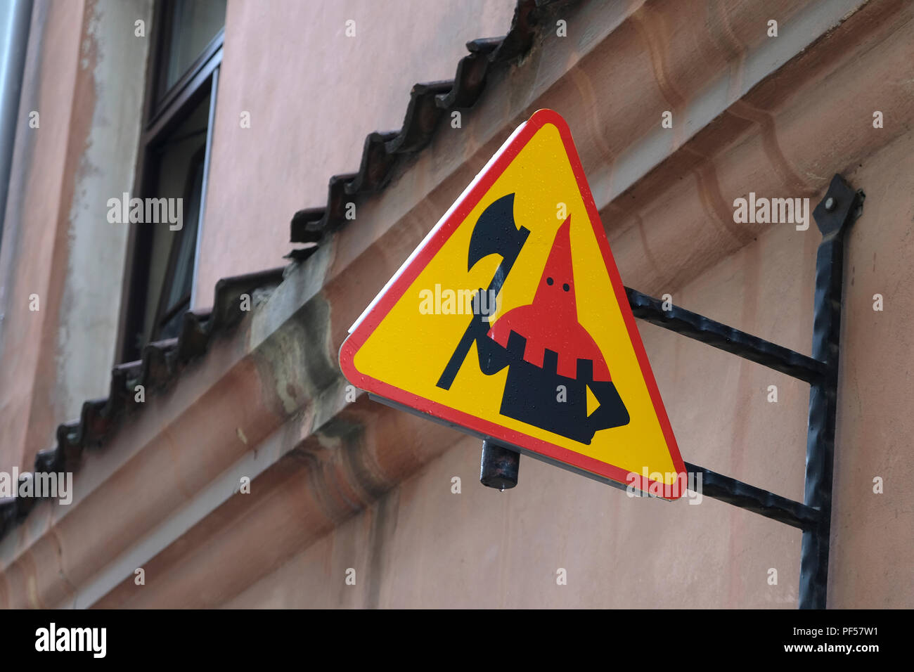 A street sign depicting a medieval executioner character with axe at ...