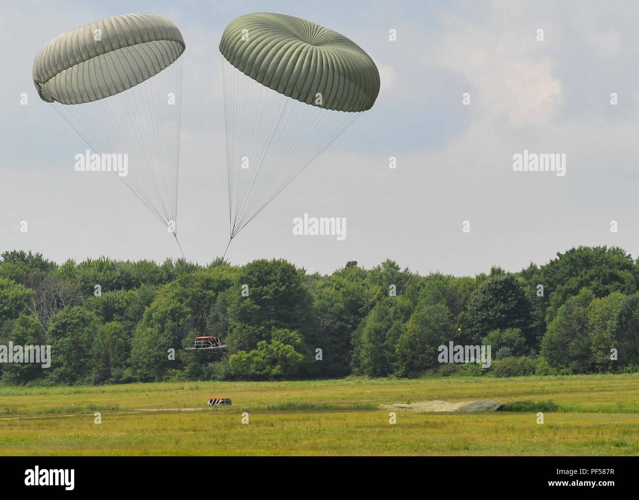 An Actual Heavy airdrop parachutes down next to another on Camp Ravenna ...