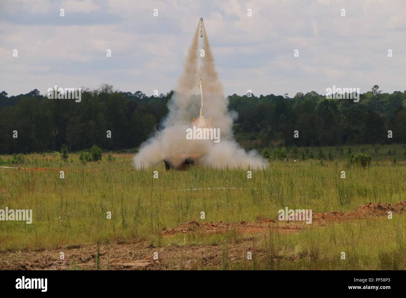A M1150 Assault Breacher Vehicle fires a M58 Mine Clearing Line Charge ...
