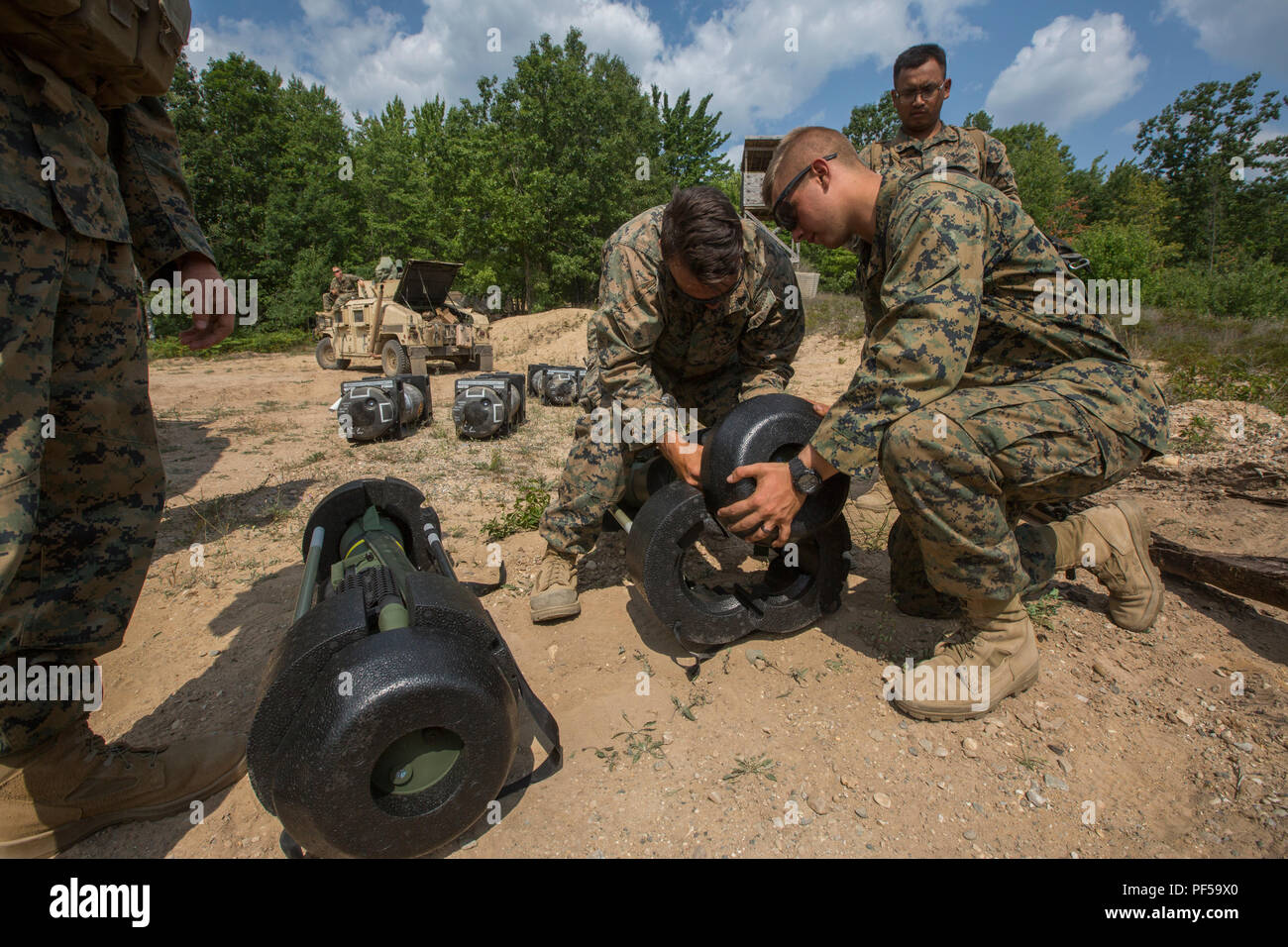 Marines with Weapons Company, 3rd Battalion, 25th Marine Regiment, inspect a FGM-148 Javelin ...