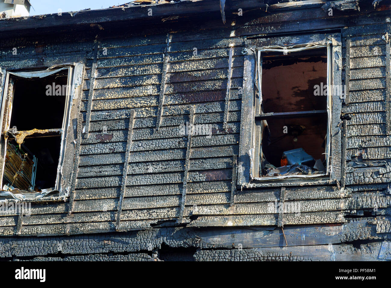 Burnt black house after fire line in front of a destroyed home Stock ...