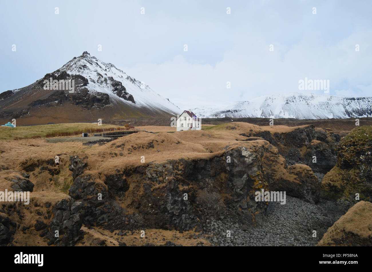 Rugged landscape and snow covered mountains surround Hellnar Iceland Stock Photo - Alamy