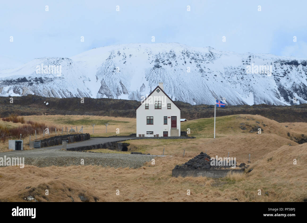Remote fishing village in Hellnar Iceland with an Icelandic flag flying ...