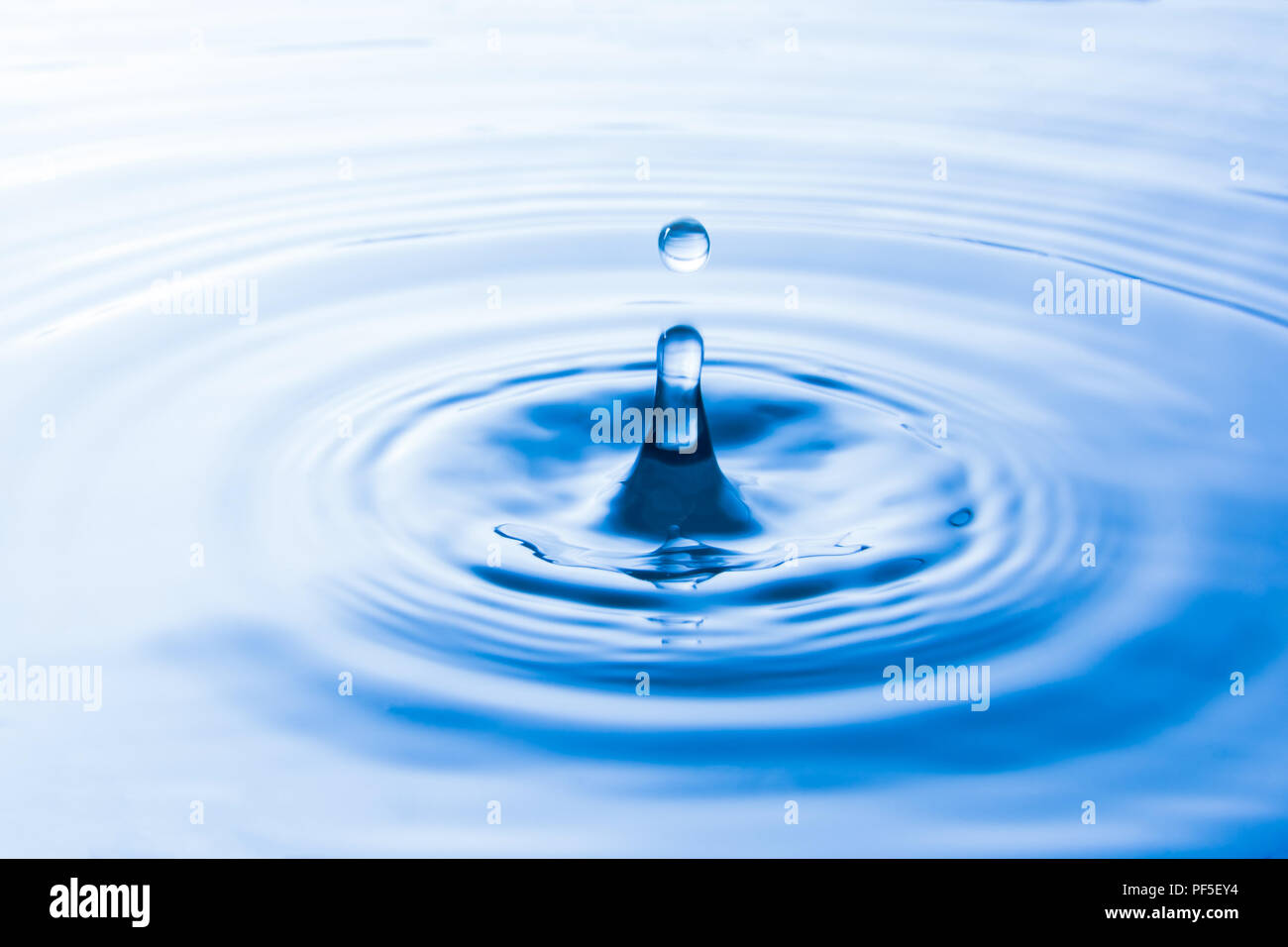 Water drop falling into water make waves. Water splash or water drop ...