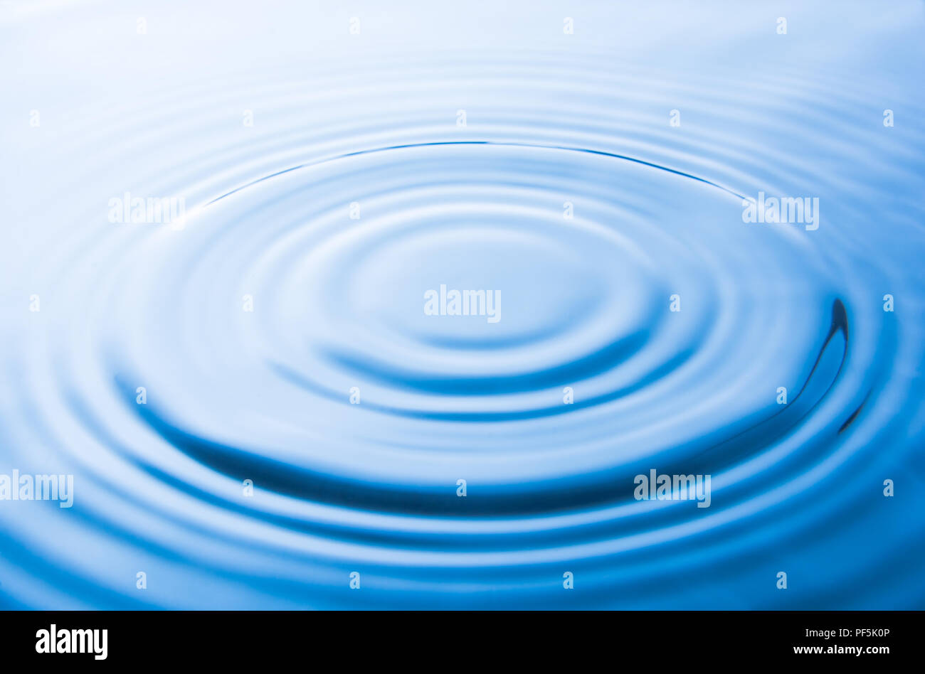 Water drop falling into water make waves. Water splash or water drop ...