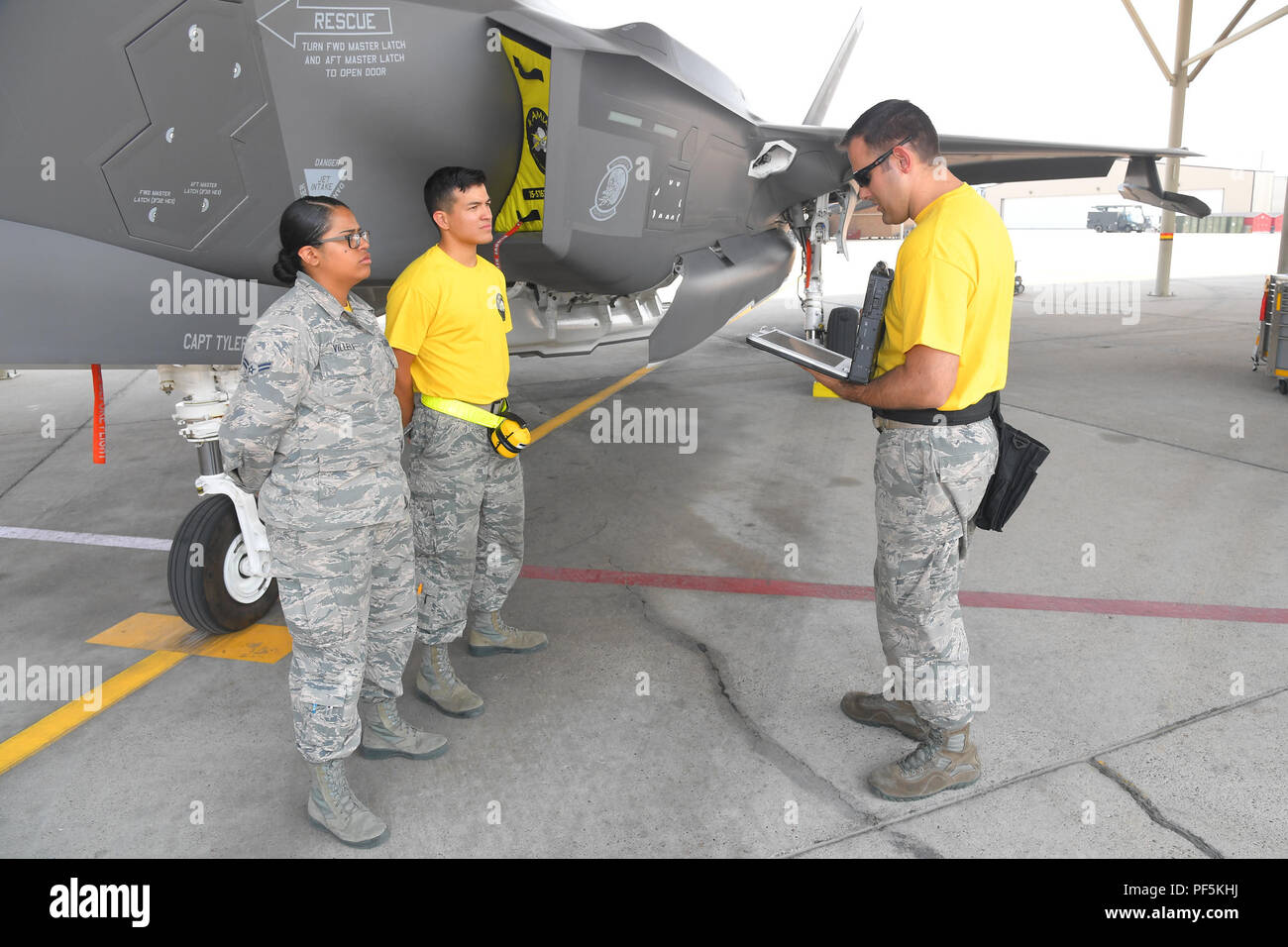 Airman 1st Class Emily Villela and Airman Baltazar Enriquez, receive a ...