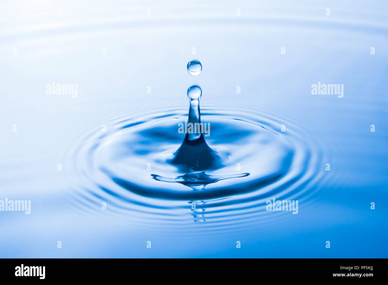 Water drop falling into water make waves. Water splash or water drop ...