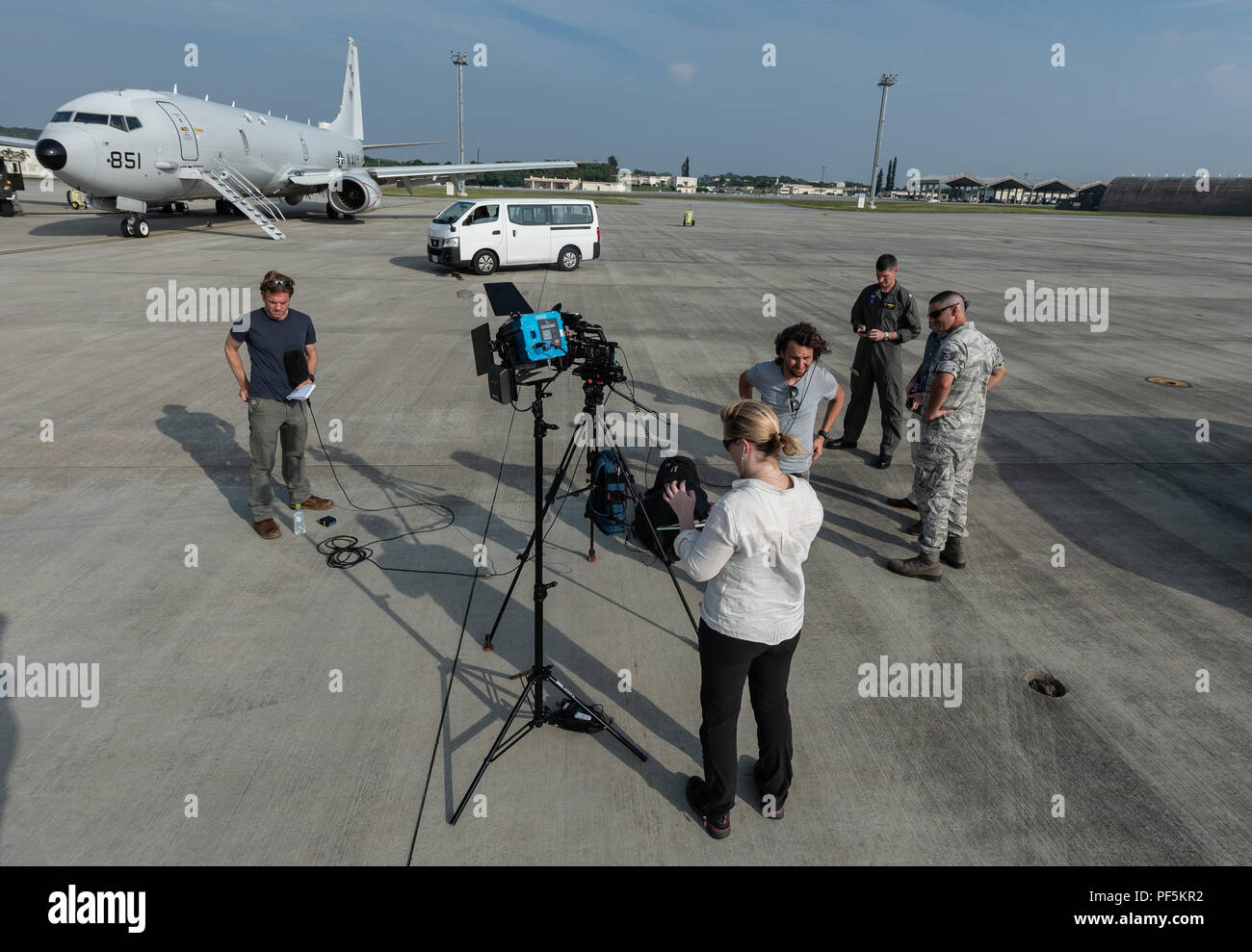 A news team from CNN prepares to go live after a flight on a U.S. Navy P-8A Poseidon Aug. 10 ...
