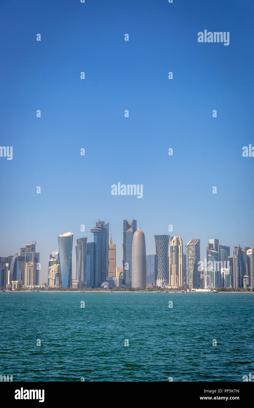 The skyline of Doha, Qatar, on a blue sky day, winter time, seen from ...
