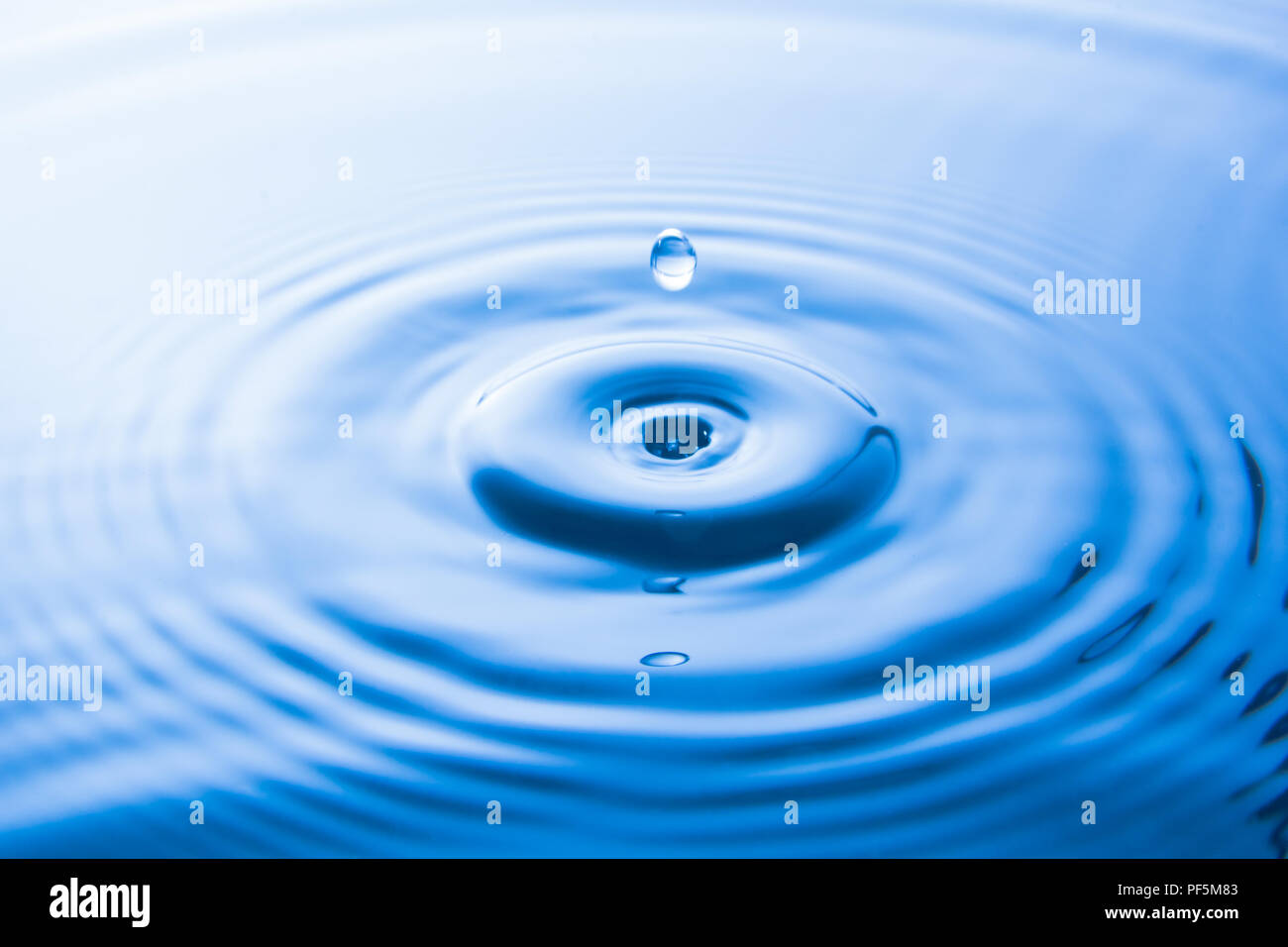 Water drop falling into water make waves. Water splash or water drop ...