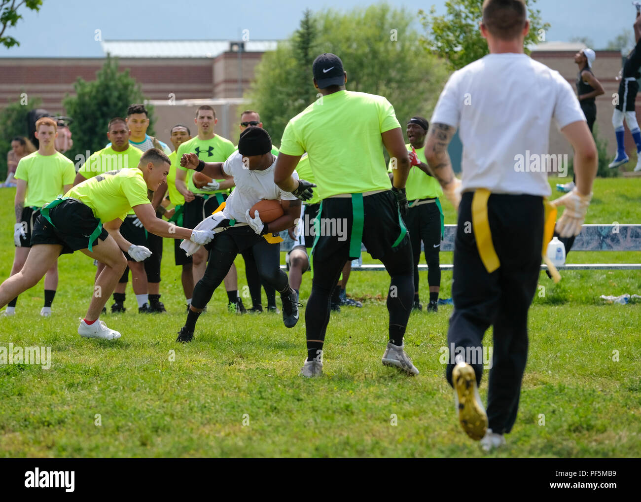 A Soldier evades the defense during a round of flag football during Ivy ...