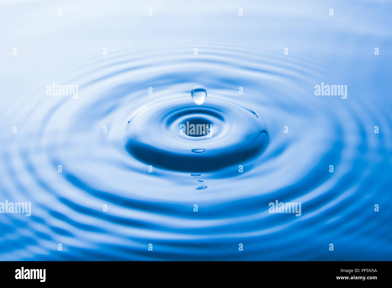 Water drop falling into water make waves. Water splash or water drop ...