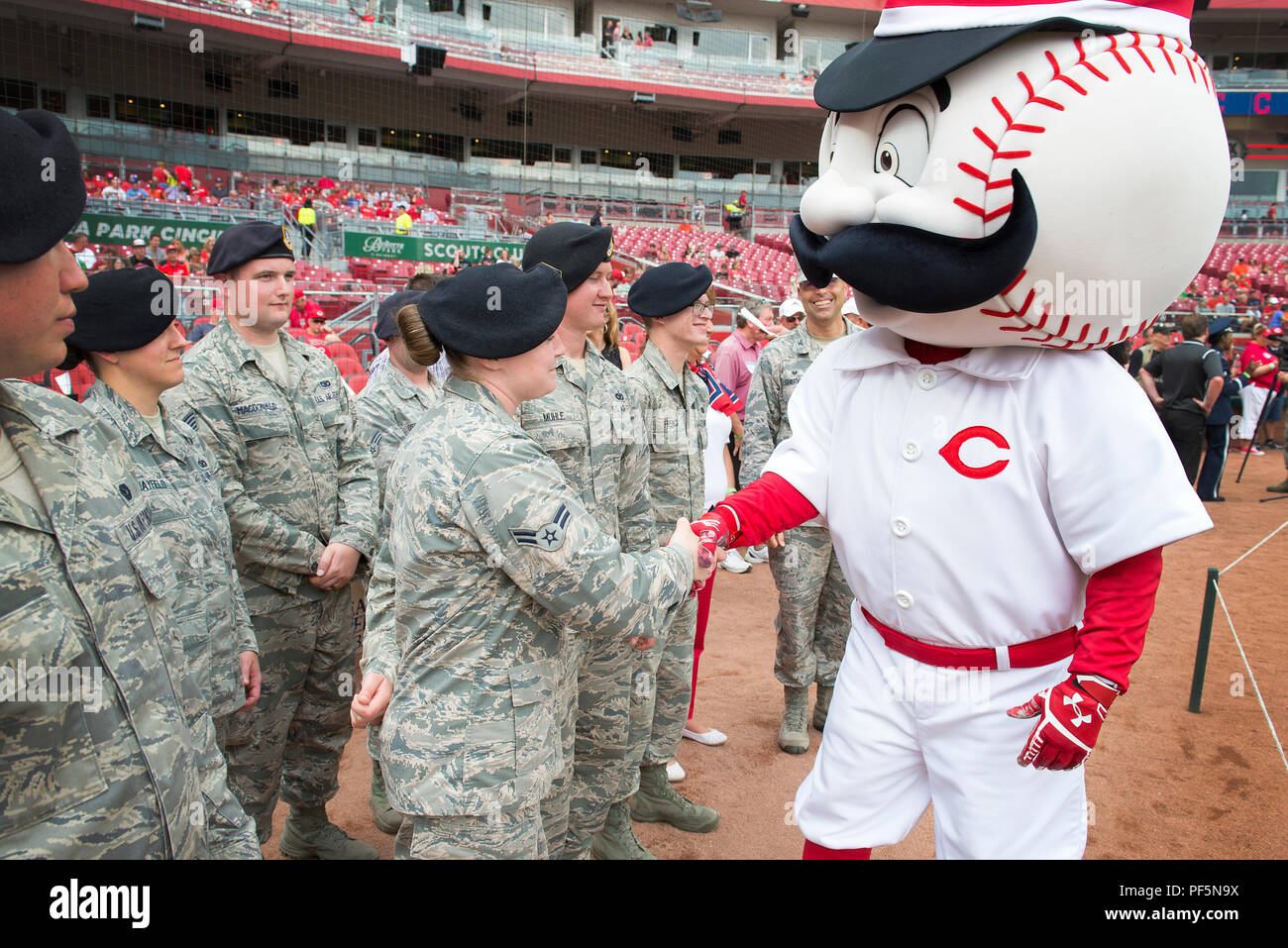 Mr. Red, mascot for the Cincinnati Reds baseball team, shakes hands ...