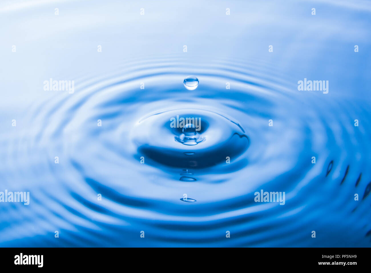 Water drop falling into water make waves. Water splash or water drop ...