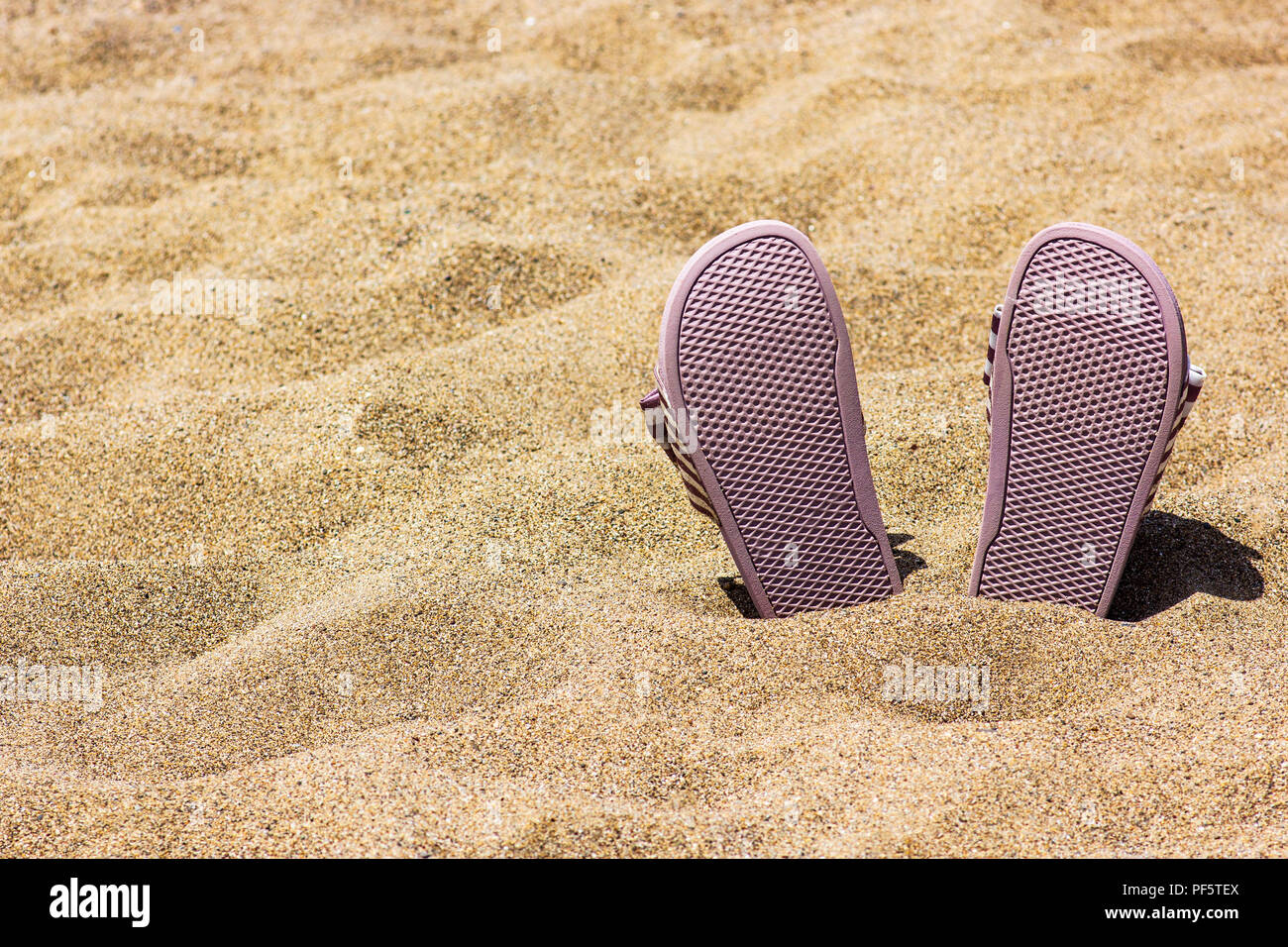 Pink beach slippers in the sand on the beach Stock Photo - Alamy