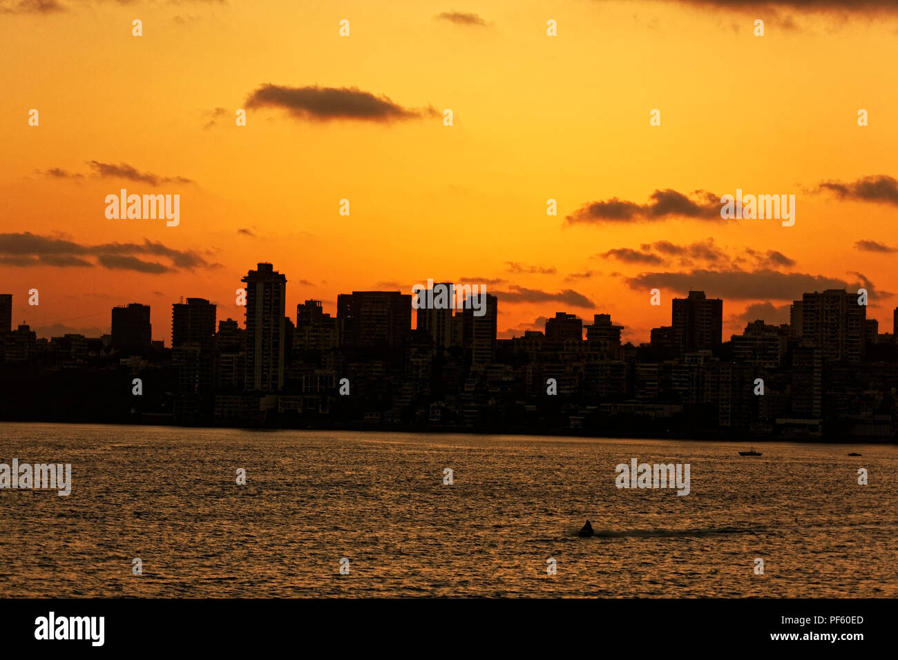 Skyline showing Walkeshwar area at sunset from marine drive in Mumbai ...