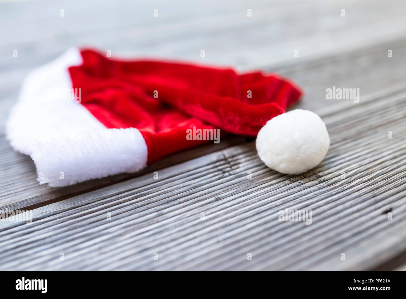 Santa hat lying on wooden floor Stock Photo - Alamy