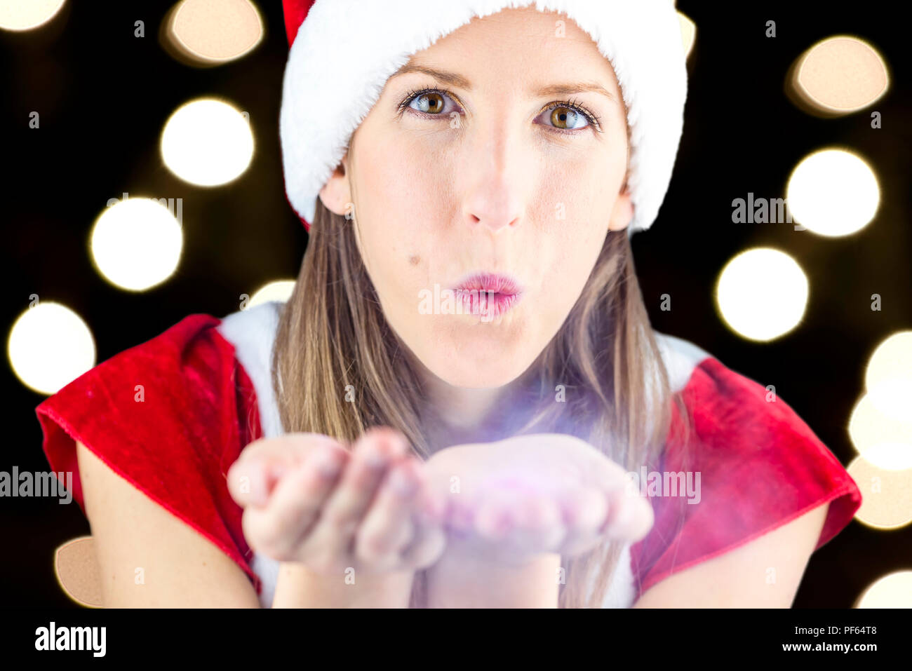 Miss Santa blowing magic wish dust at you. With christmas lights in ...