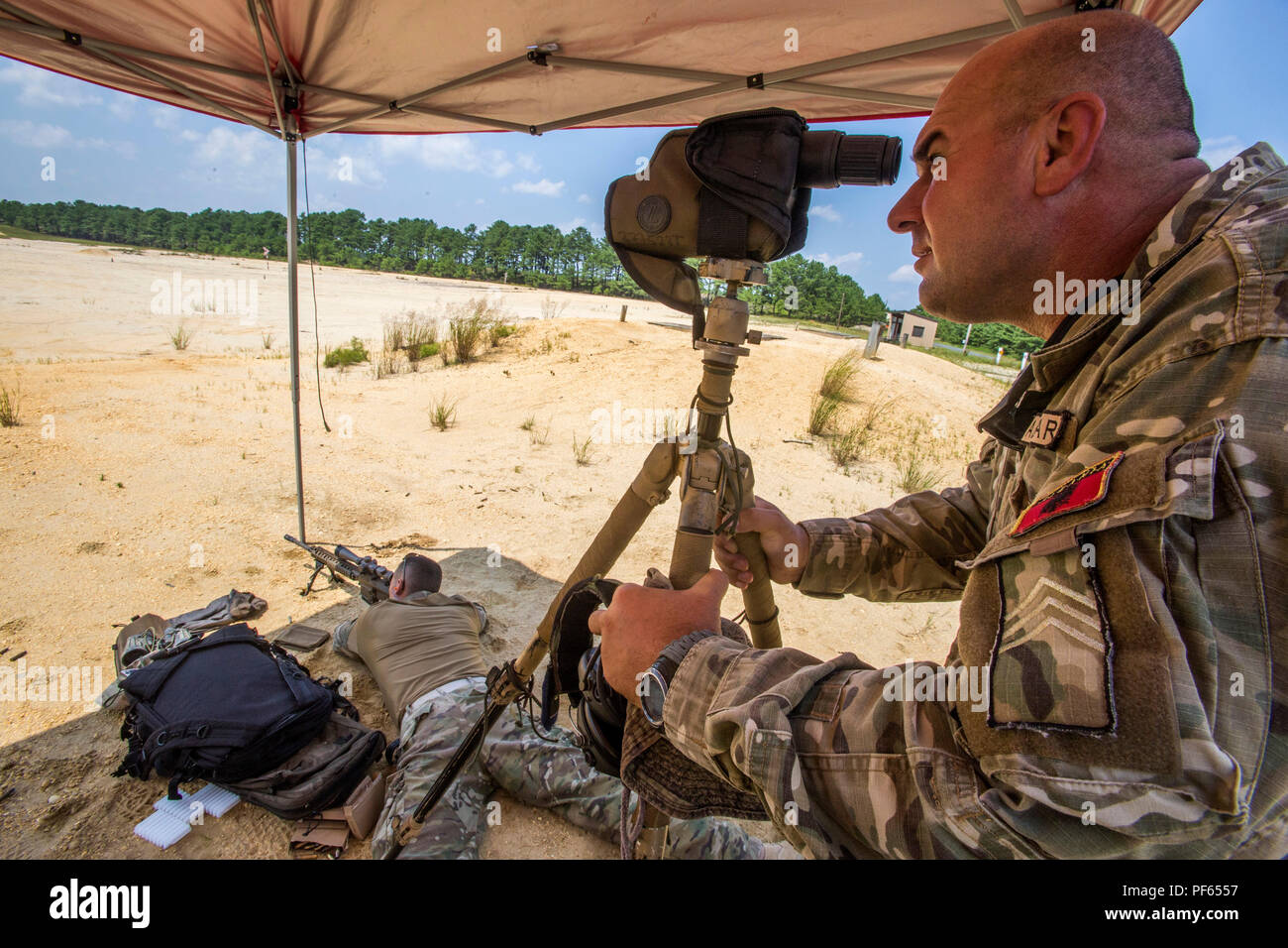 Albanian special forces sniper Staff Sgt. Rexhep Gjeta, right, spots ...